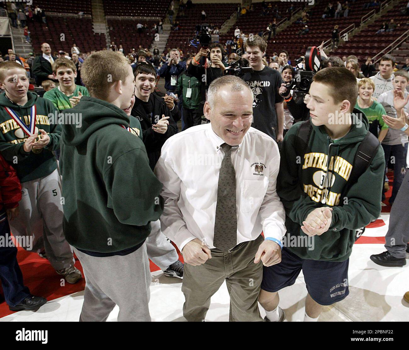 Central Dauphin High School head wrestling coach Jeff Sweigard, center ...