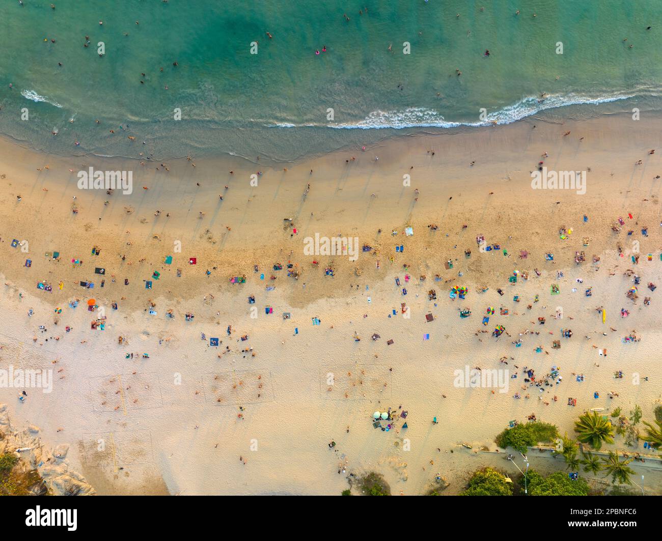 aerial top view above white sand beach. beach crowded with tourists ...