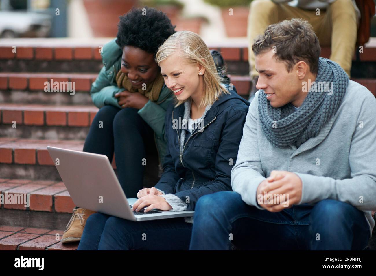 ...on campus. a group of university students looking at something on a ...
