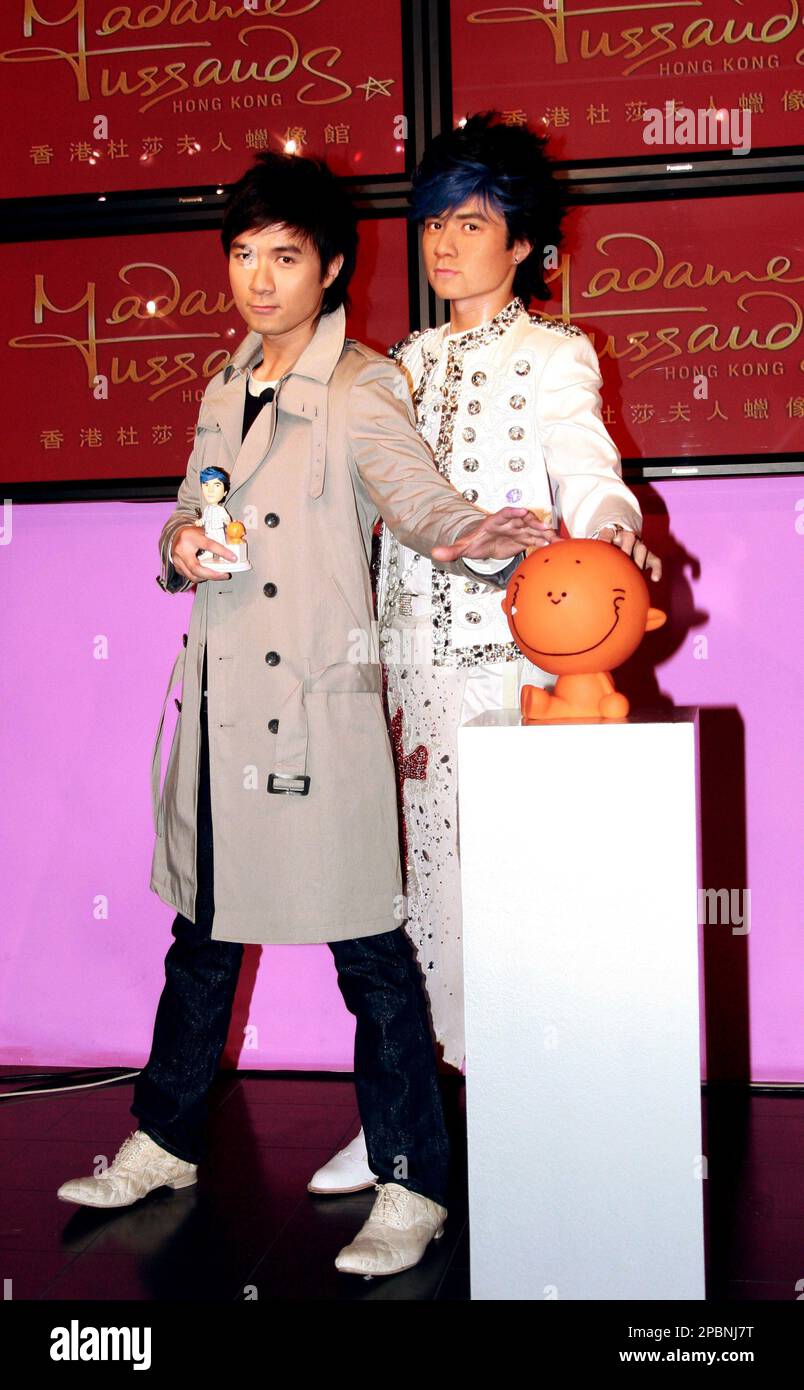 Hong Kong singer Leo Koo, left, poses with a wax figure of himself at ...
