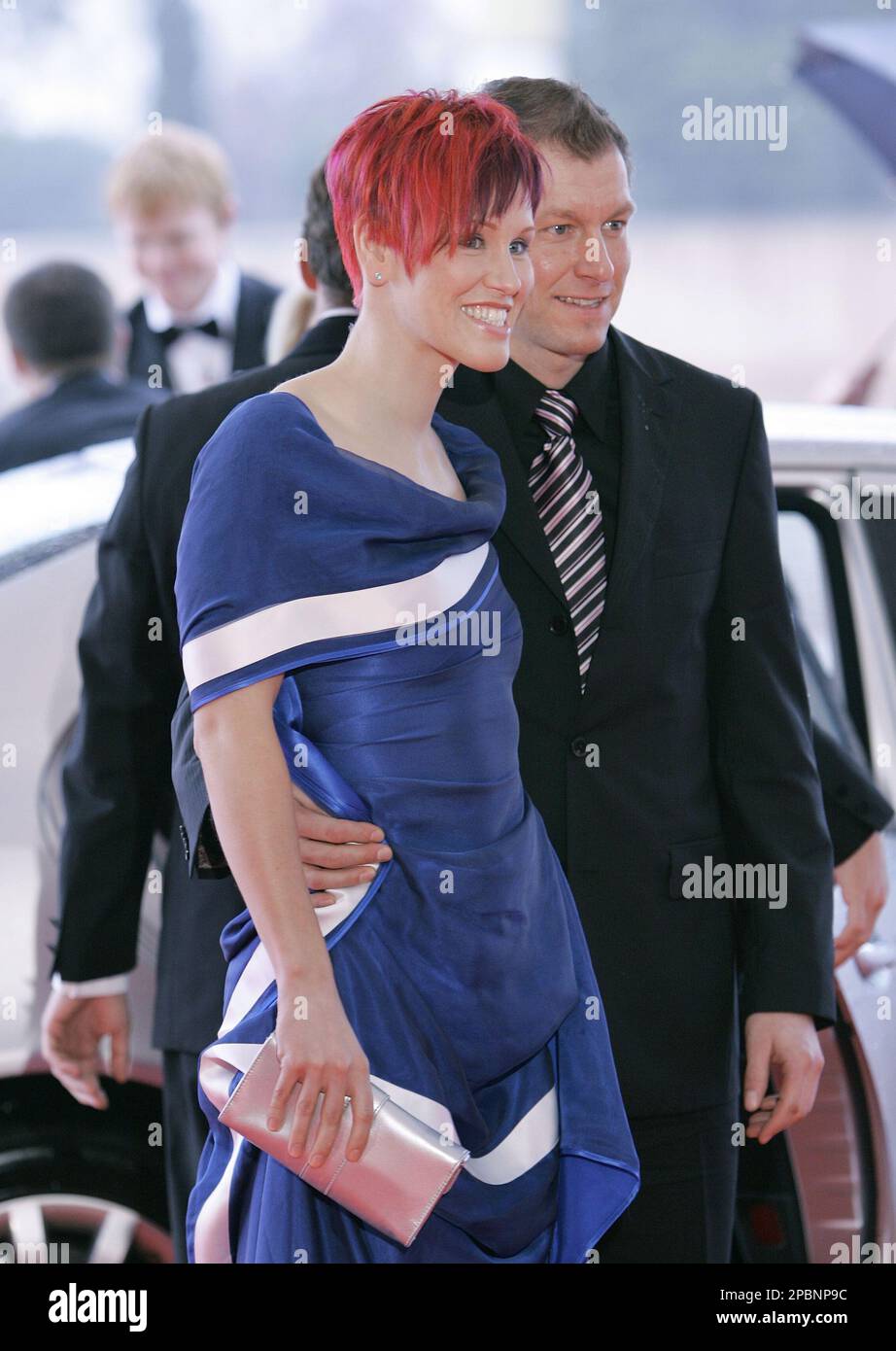 German Kati Wilhelm, left, arrives with an unidentified partner for the ...