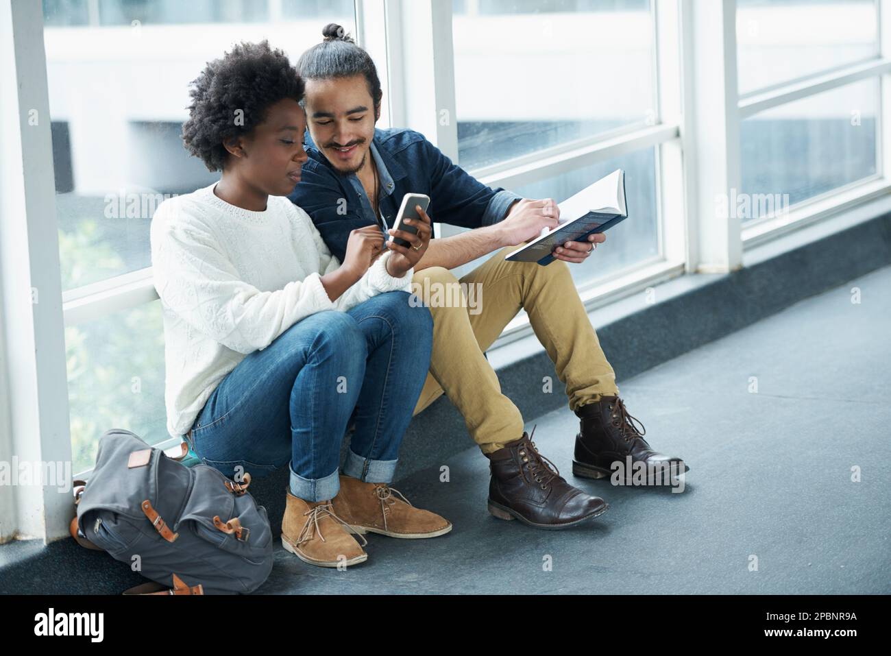 Bonding over knowledge. A college couple sitting closely together ...