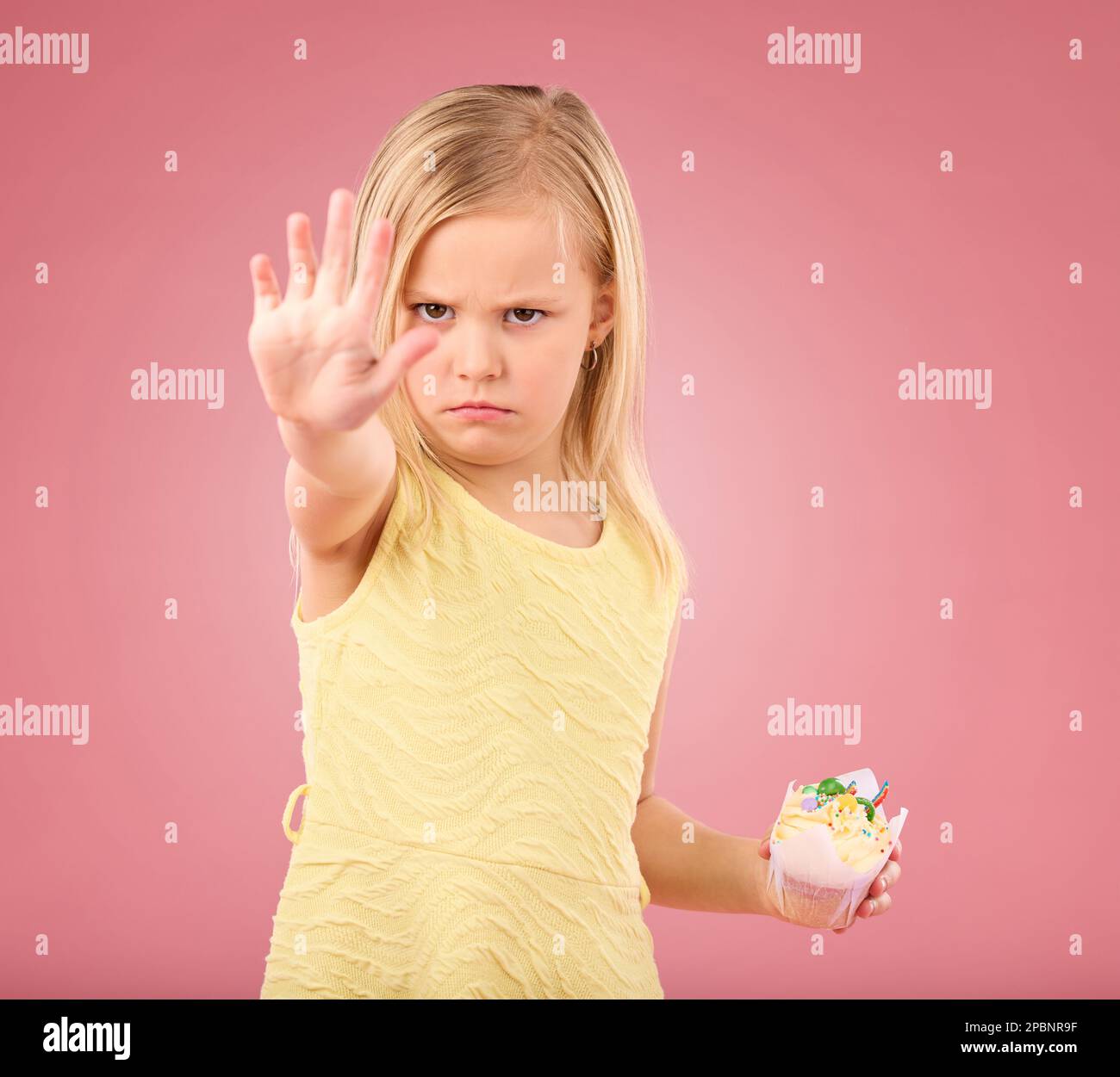 Stop, angry and child portrait with a no hand gesture and cupcake ...