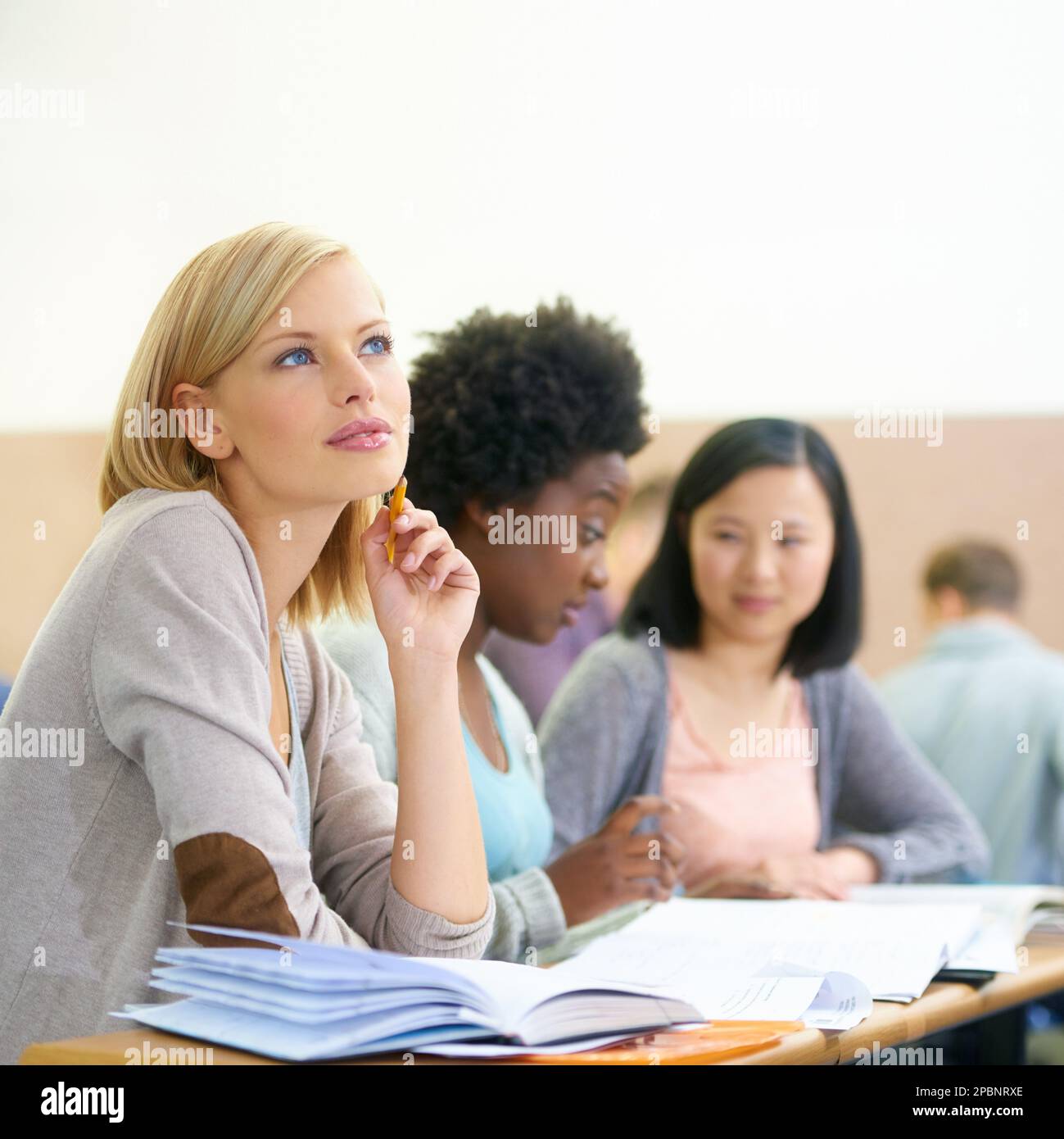 Thinking of the weekend...female university students sitting in an exam ...