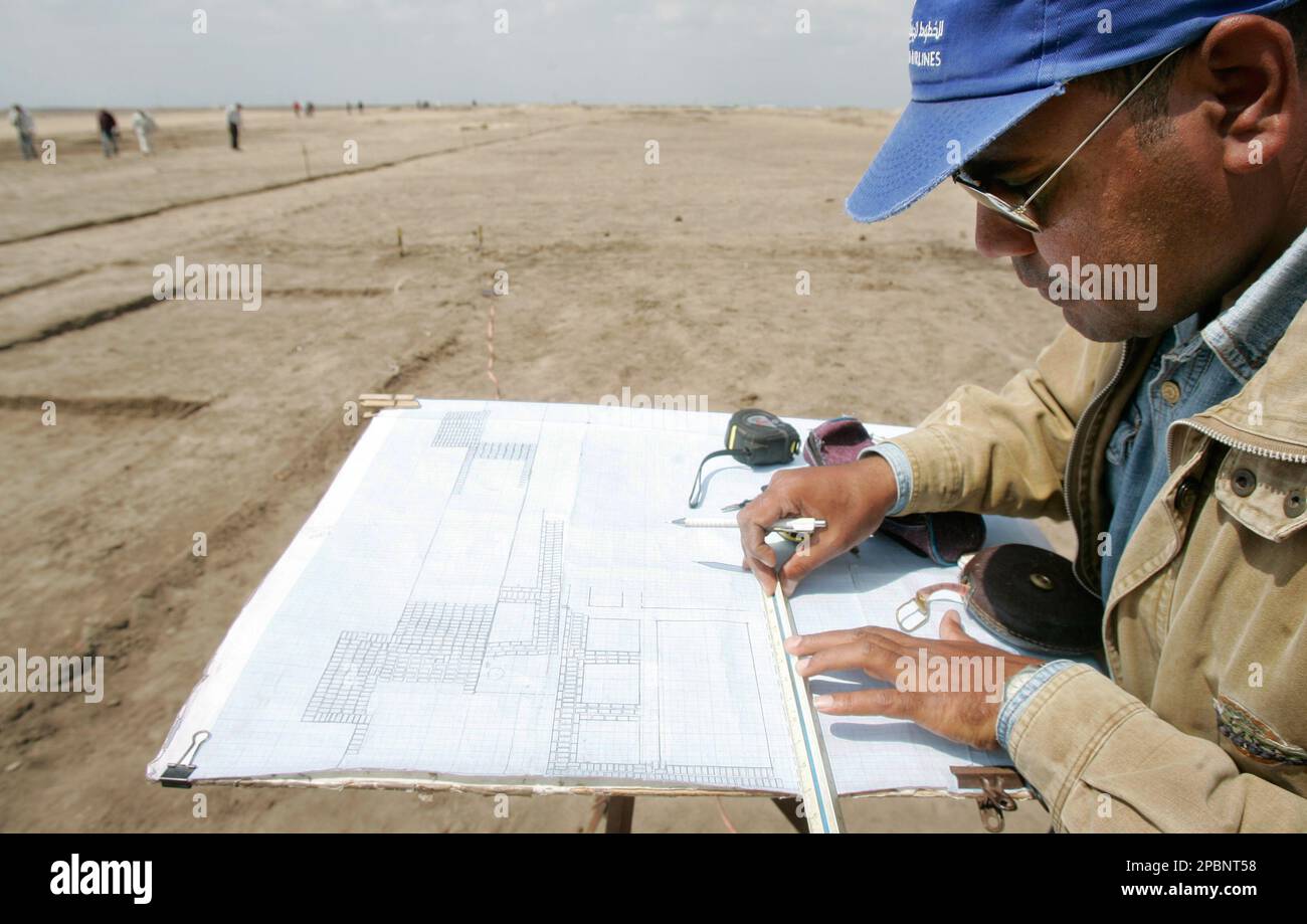 An archaeological engineer looks at plans of the area at the unveiling ...