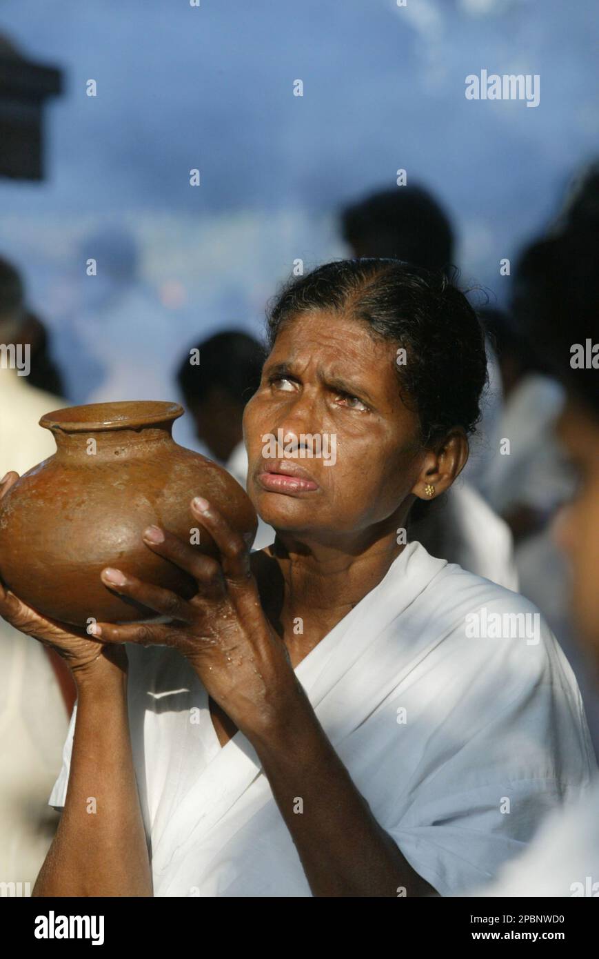 A Sri Lankan Buddhist devotee offers full moon day rituals at the ...