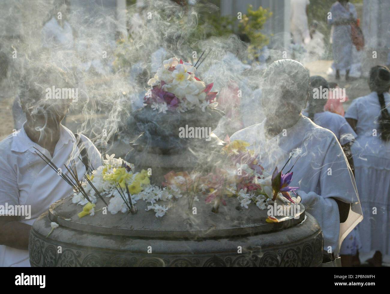 A Sri Lankan Buddhist devotee offers full moon day rituals at the ...