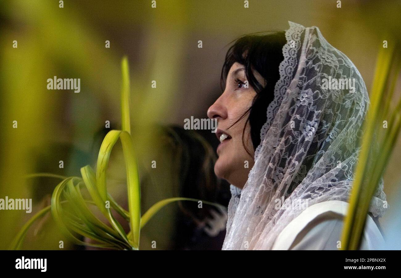 A faithful Christian woman pries during a Palm Sunday mass in Bogota ...