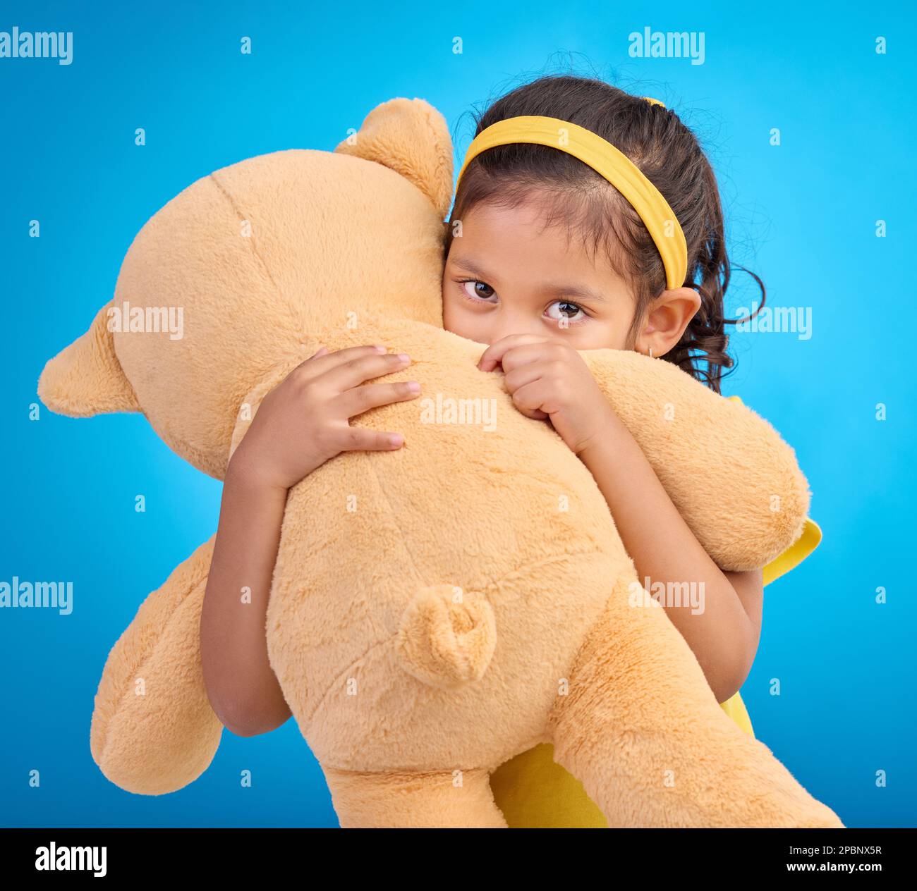 Portrait, hug and child in studio with teddy bear, sweet and innocent ...