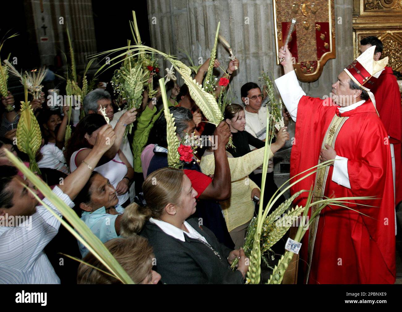 Mexican Cardinal Norberto Rivera blesses the crowd with holy water ...