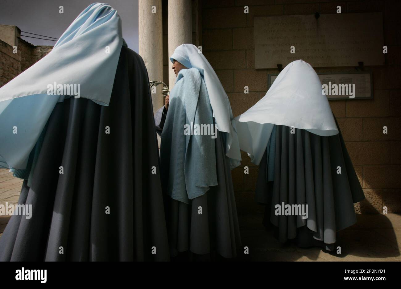 Catholic nuns hold olive branches as they participate in the ...