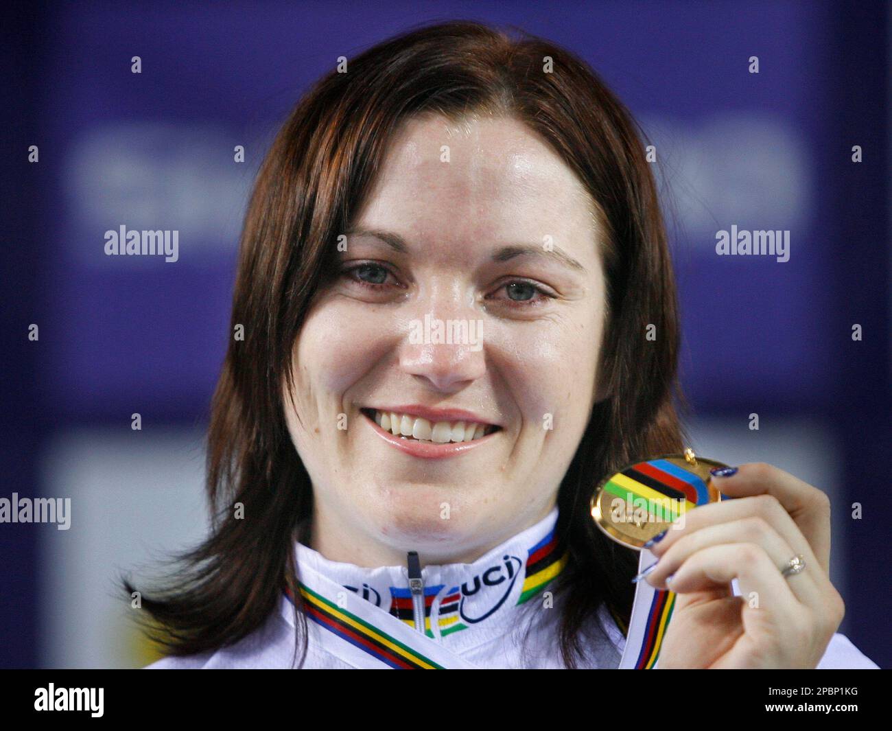 Australian cyclist Anna Meares poses with her gold medal after wining ...