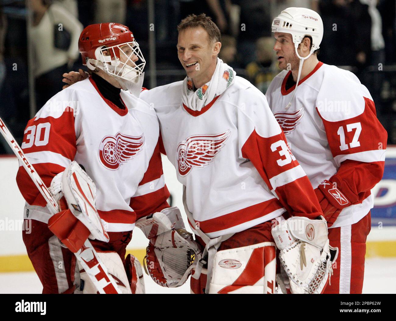 Detroit Red Wings goalie Chris Osgood (30) is congratulated by Dominik ...