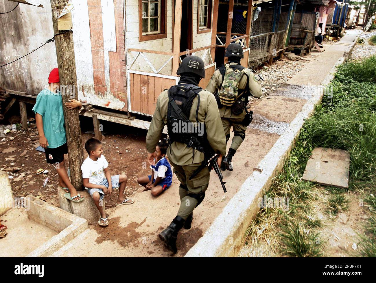 Two special forces police officers patrol the Curundu slum during an ...