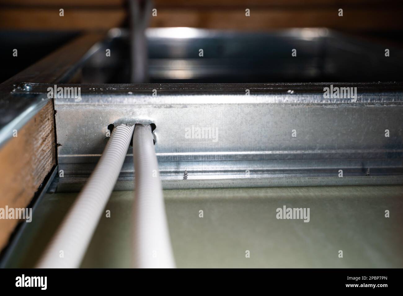 The wires in the protective corrugated pipe are led through the hole ...