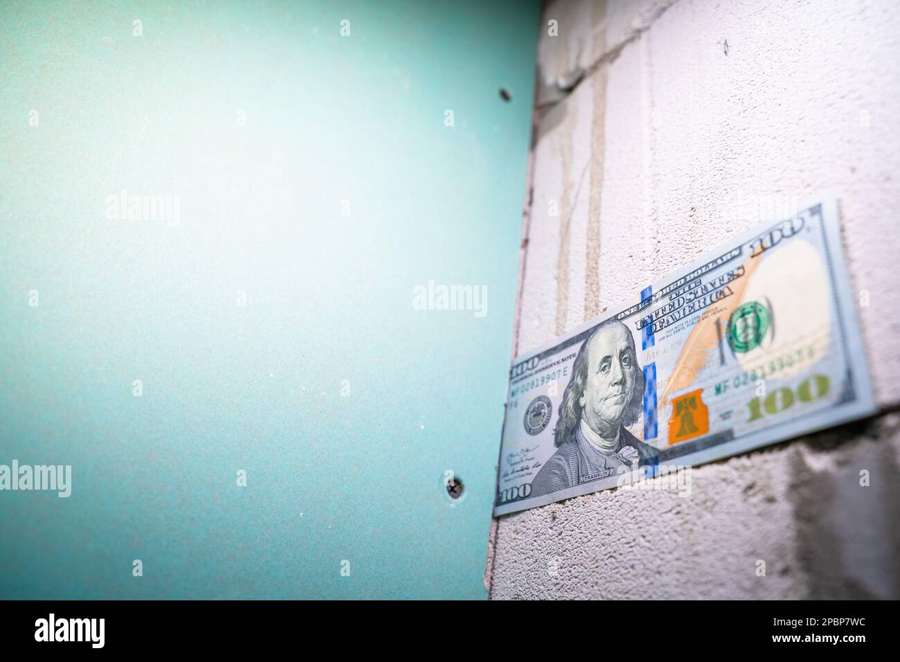 One hundred dollars close-up on aerated concrete brick near moisture ...