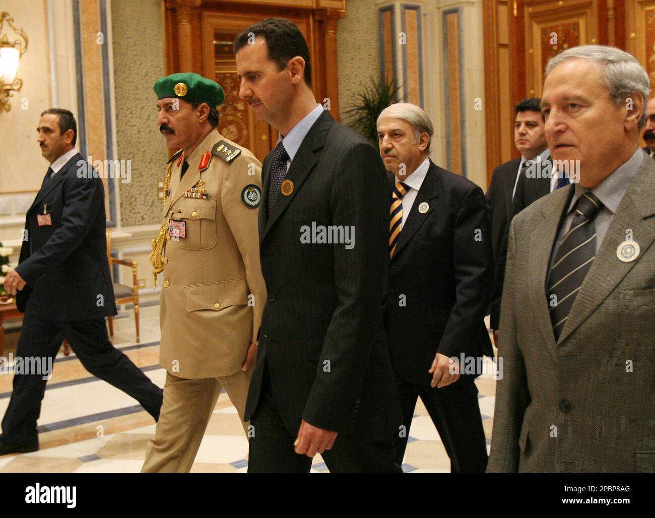Syrian President Bashar Assad, center leaves after attending the closing session of the annual ...