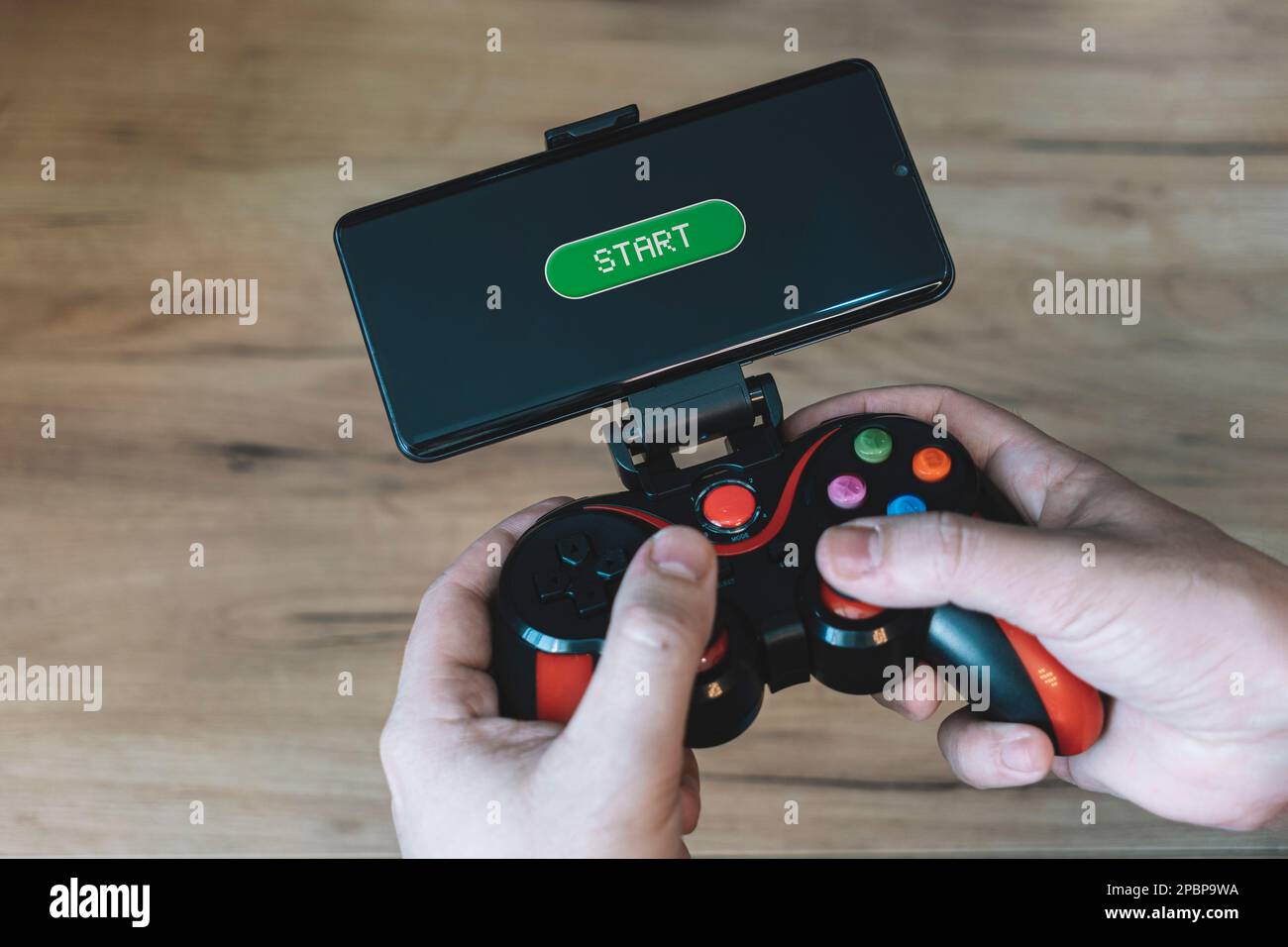 Hands with joystick with phone. a gamer plays on a smartphone Stock ...