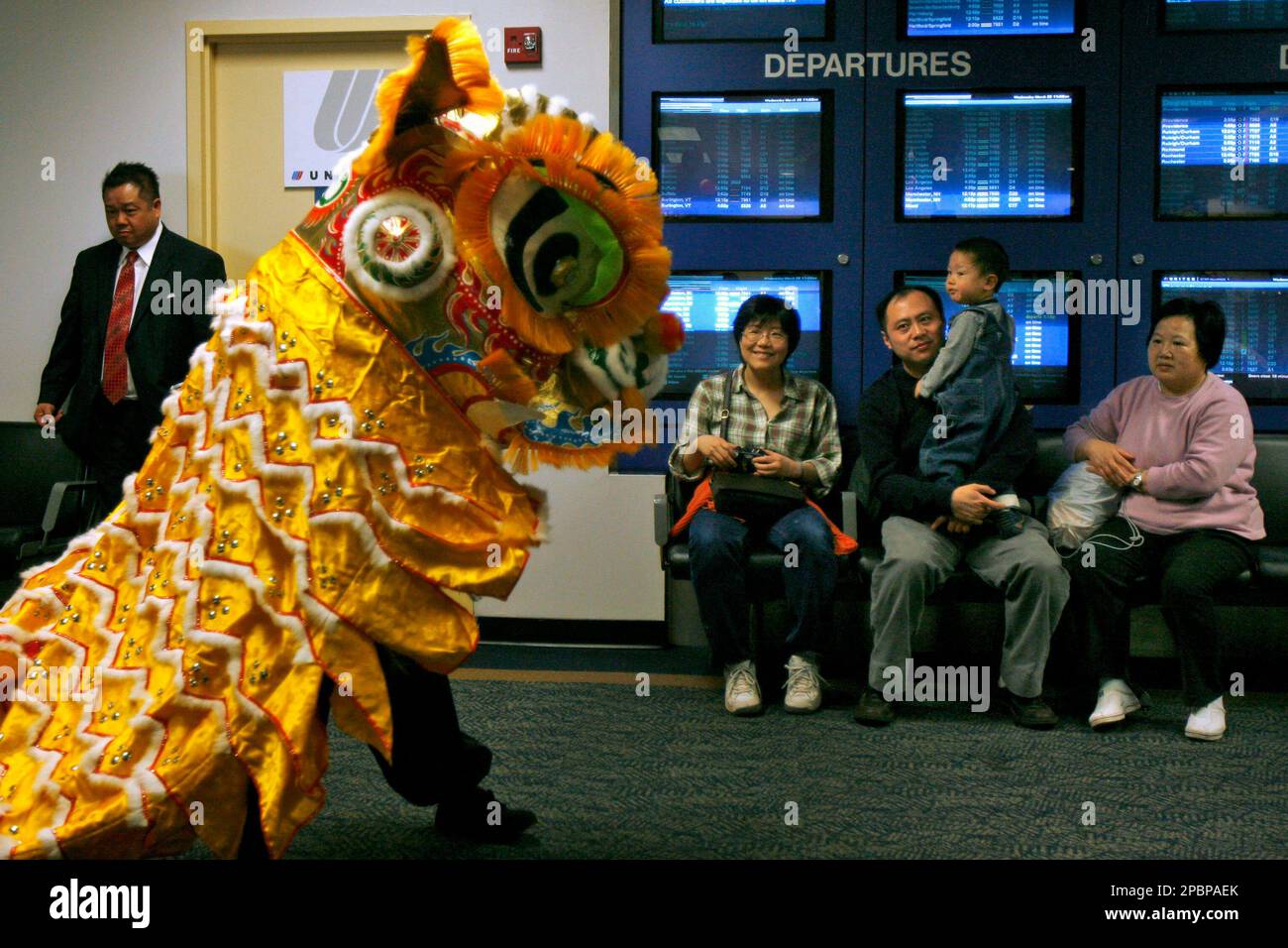 Lei Zhang, background left, sits with her husband, Hui Jiang, son, Wang ...