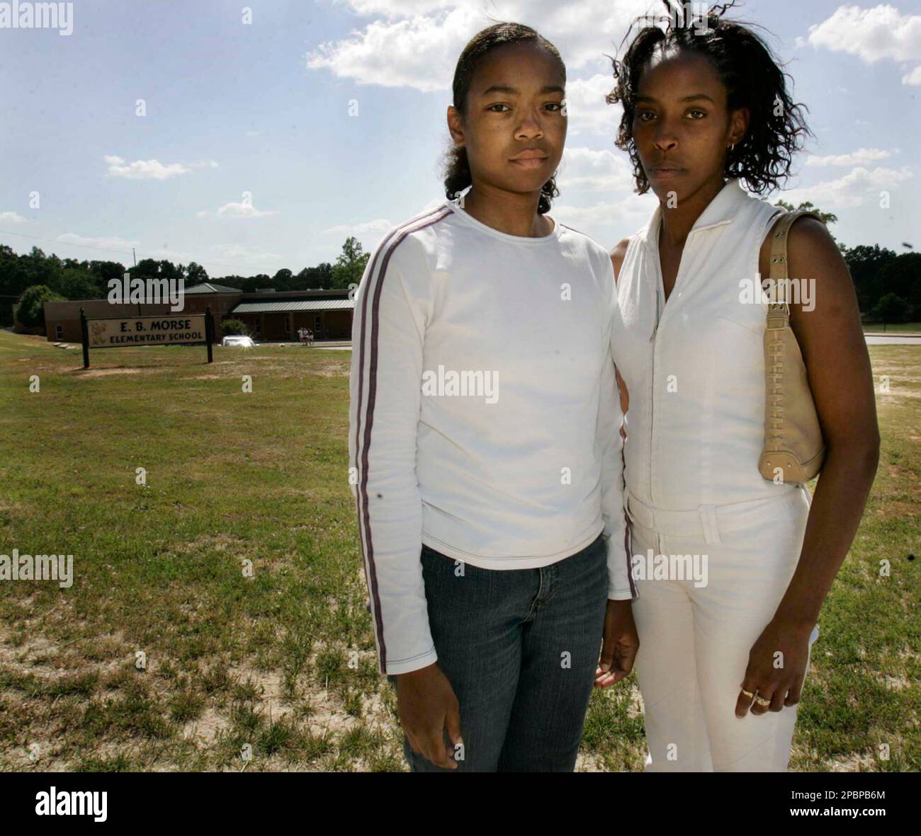 Parents Shea Mills, left and Nicole Sullivan, right, stand outside E.B ...