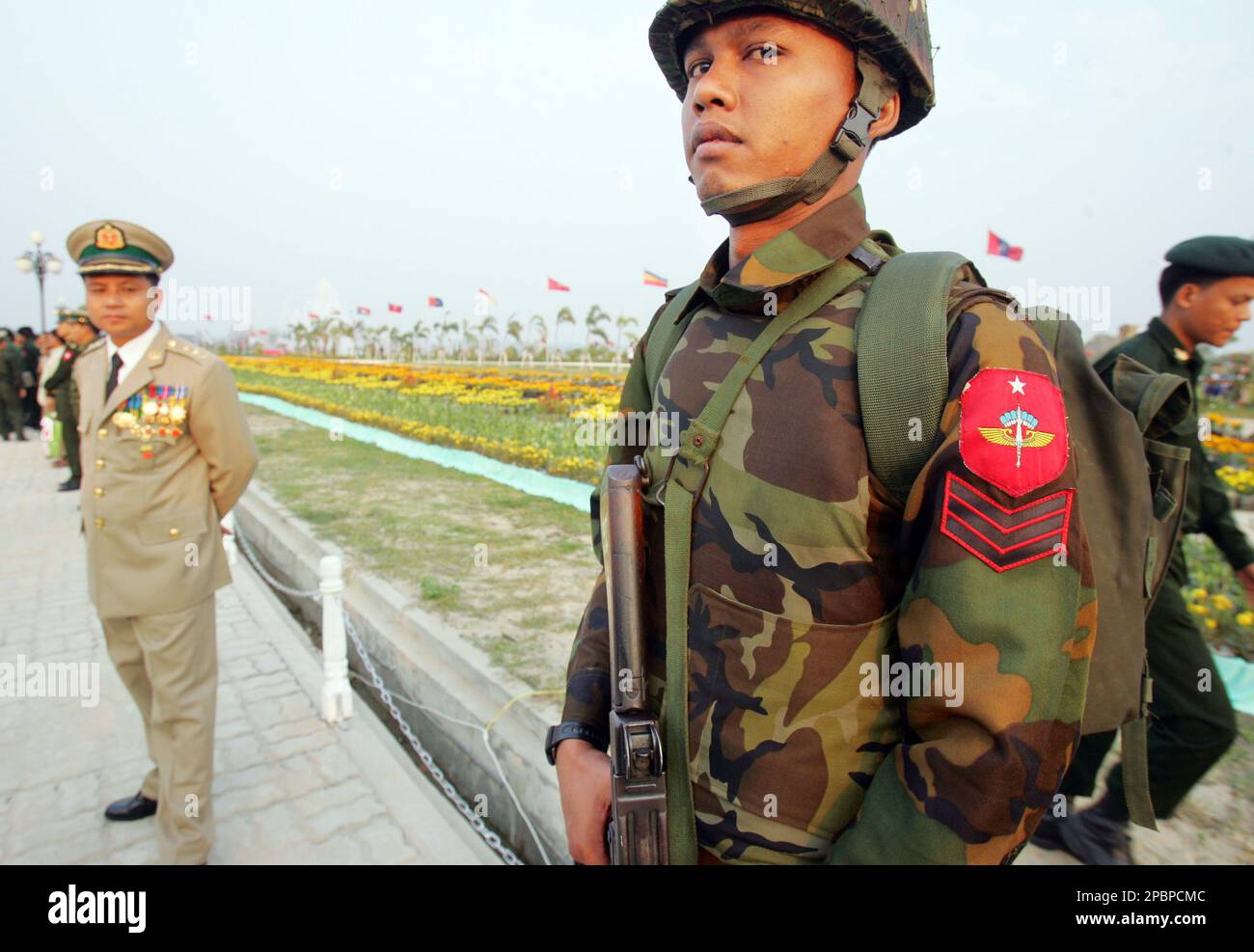 A Myanmar soldier looks on as he is photographed Tuesday, March 27 ...
