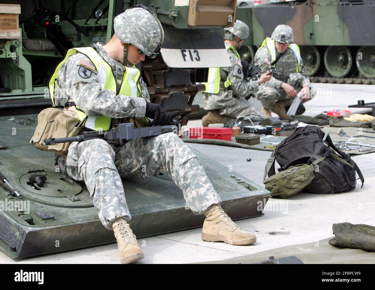 A U.S. Army soldier checks his machine gun during joint exercises with ...