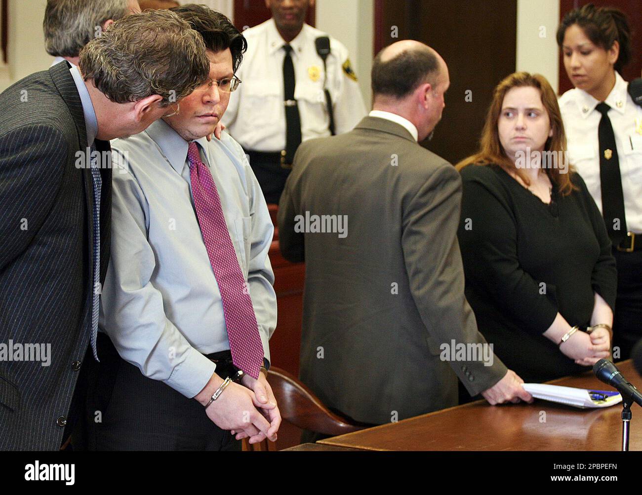 Attorney John Darrell , left, speaks to Michael Riley, second from left ...