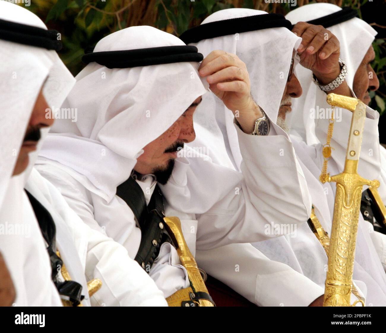 Members of a traditional Saudi honor guard with their golden swords ...