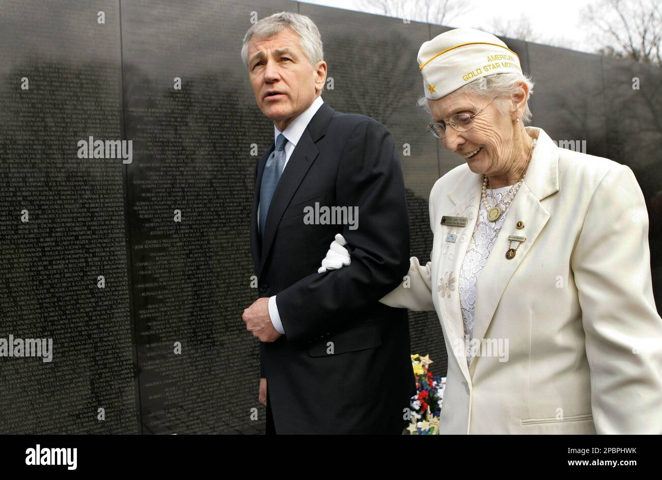 Sen. Chuck Hagel, R-Neb., left, walks with Betty Jean Pulliam, national ...