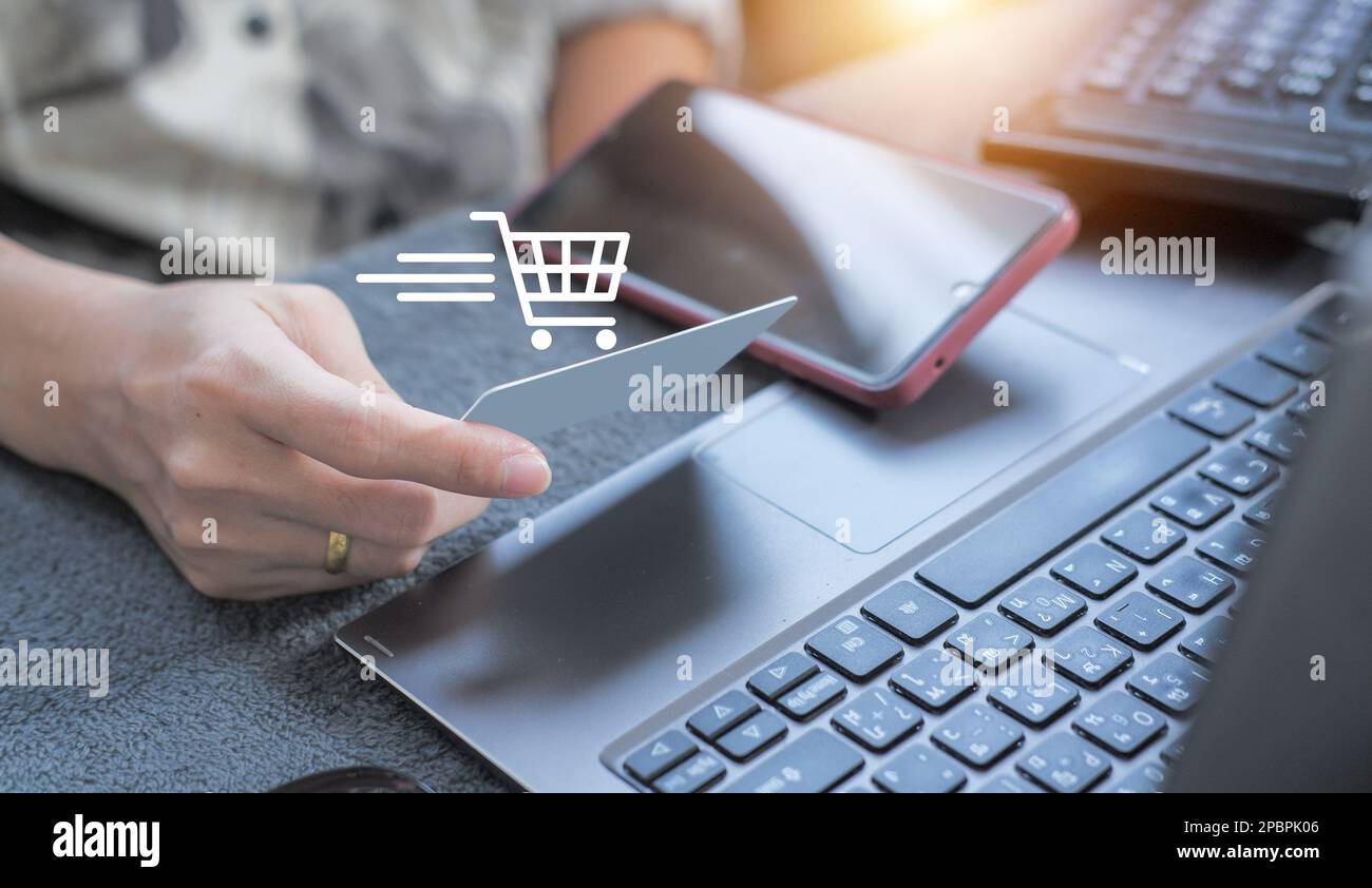 Woman using credit card filling billing information on laptop computer ...