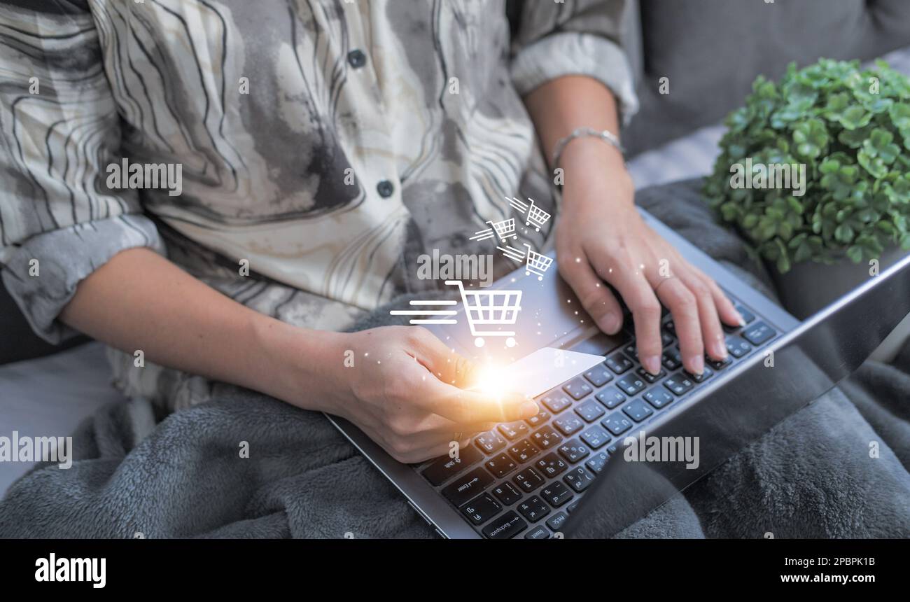Woman using credit card filling billing information on laptop computer ...