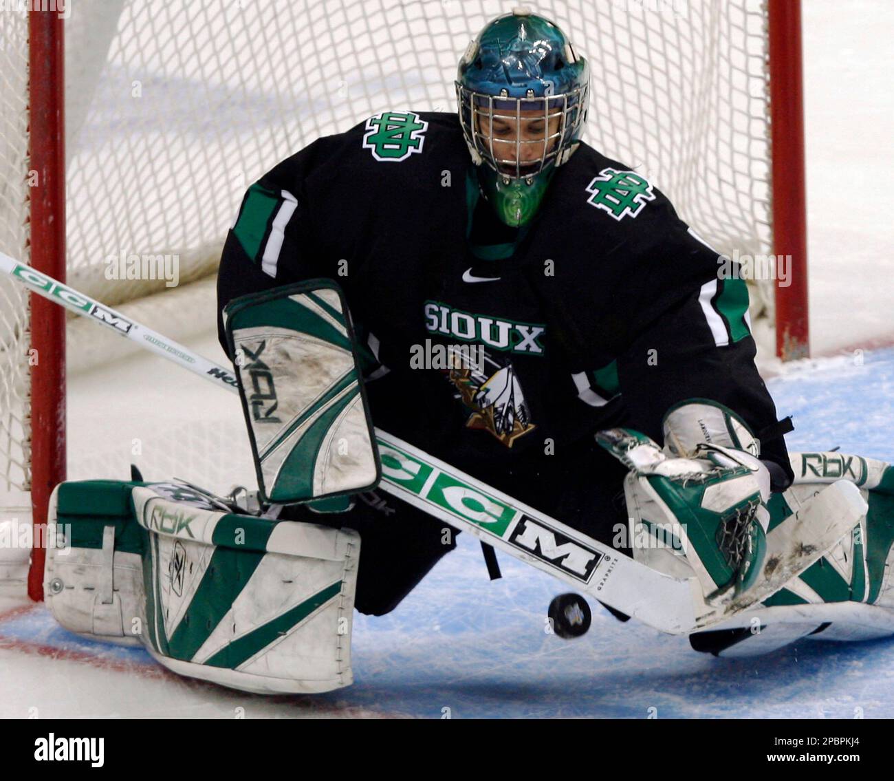 North Dakota goalie Philippe Lamoureux makes a stick save of a shot by ...