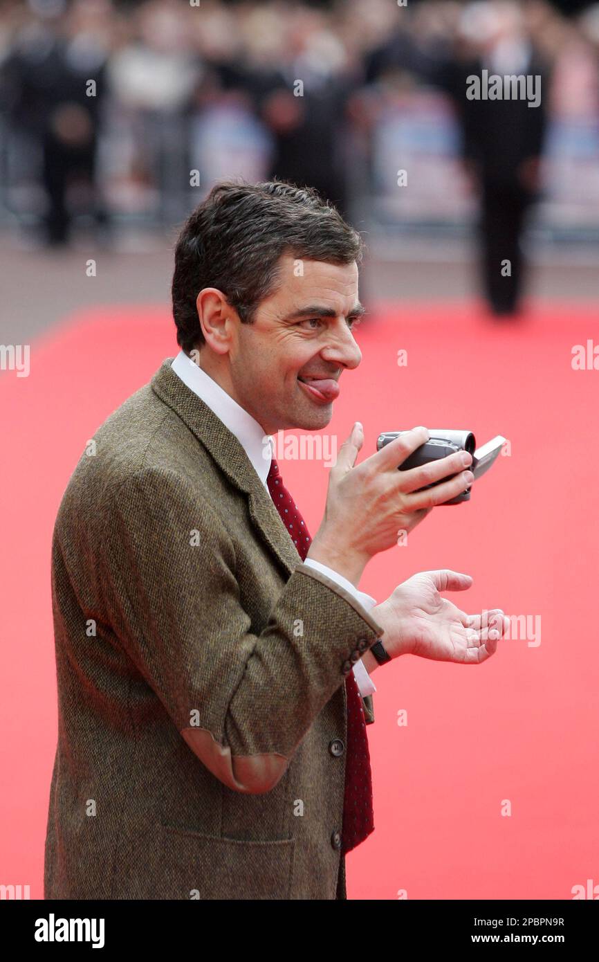 British actor and comedian Rowan Atkinson films the crowd with his ...