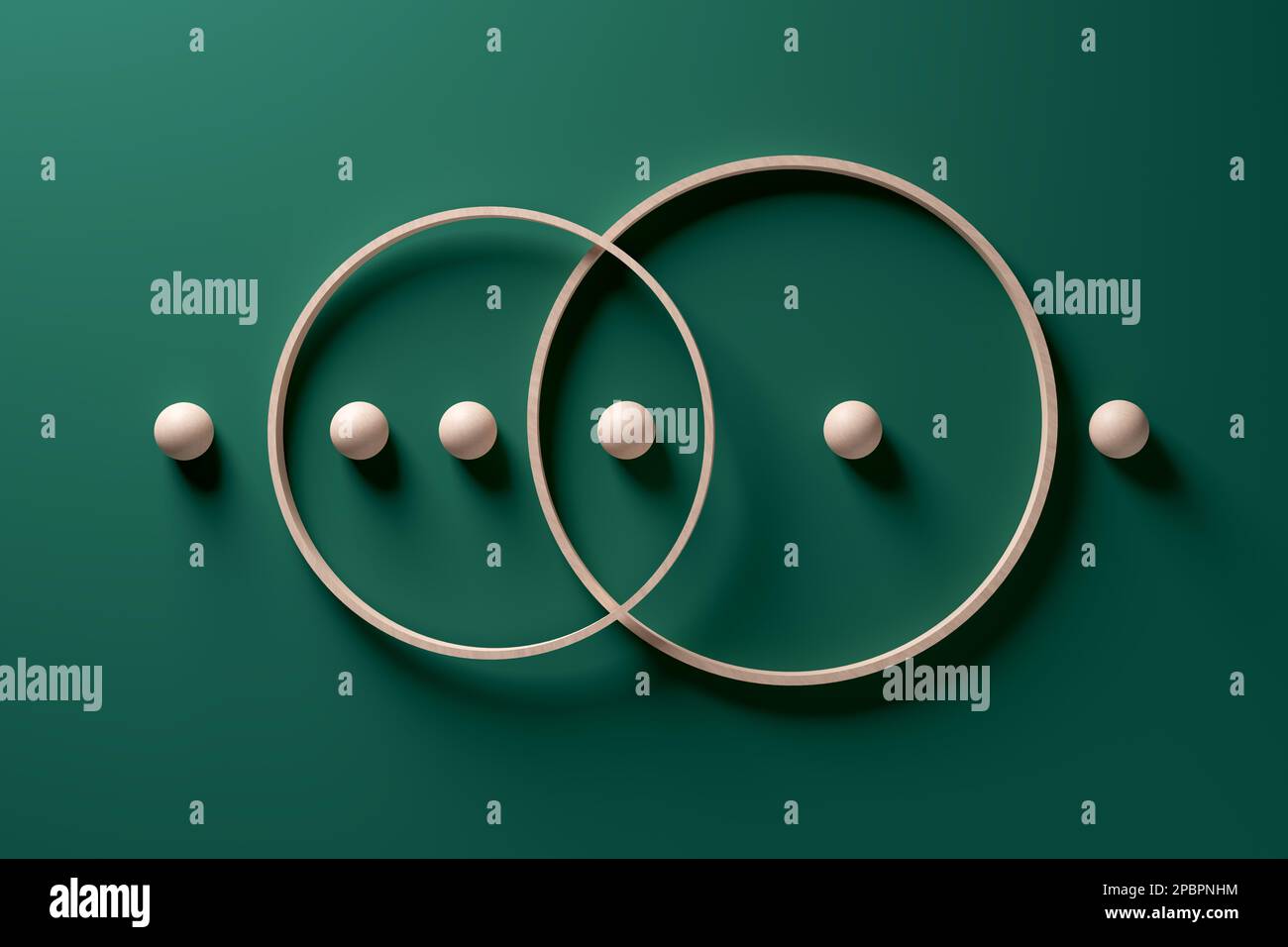 Crossing wooden rings with spheres in a row on green background. Modern ...