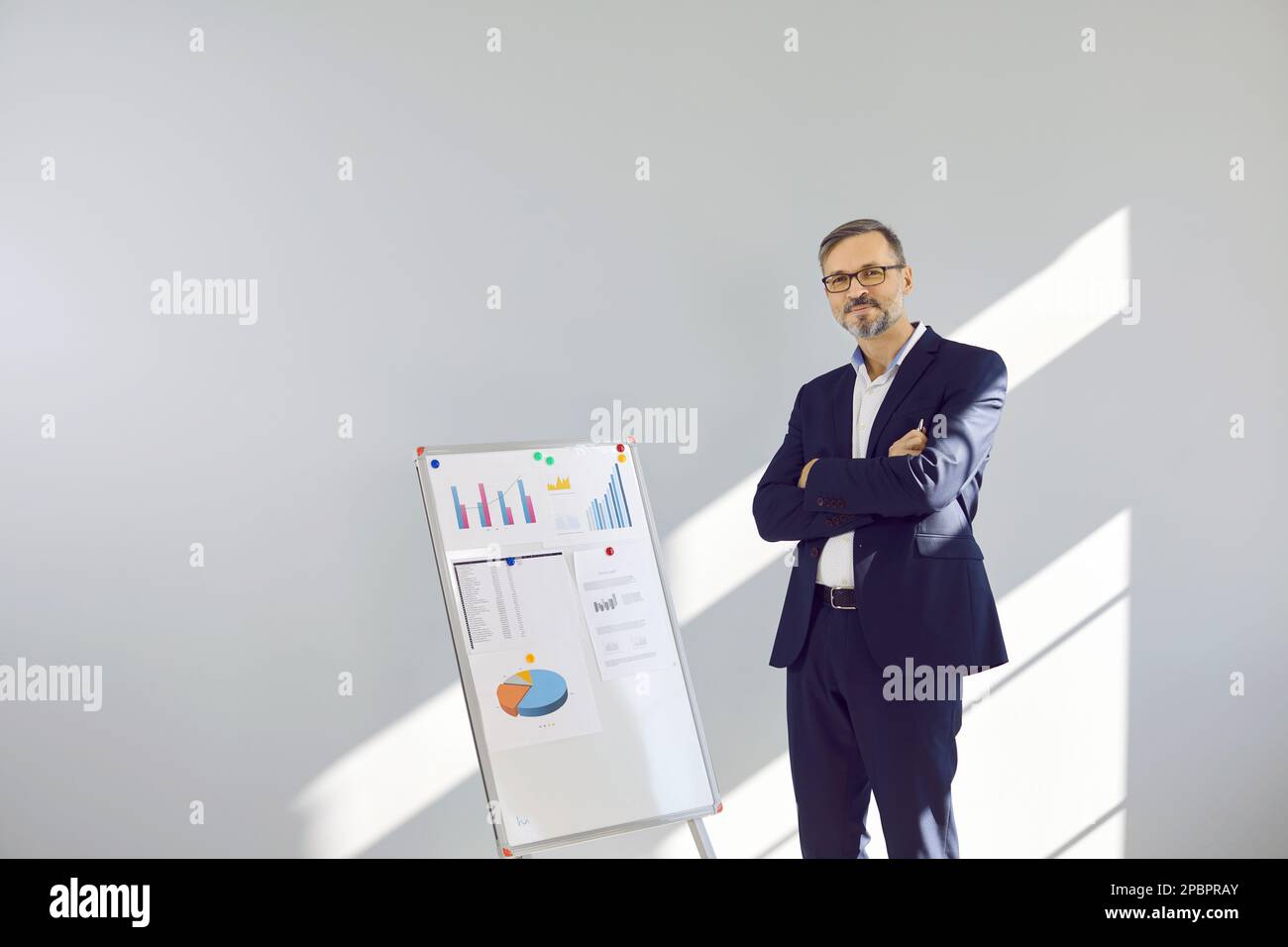 Happy professional sales or marketing manager standing in front of ...