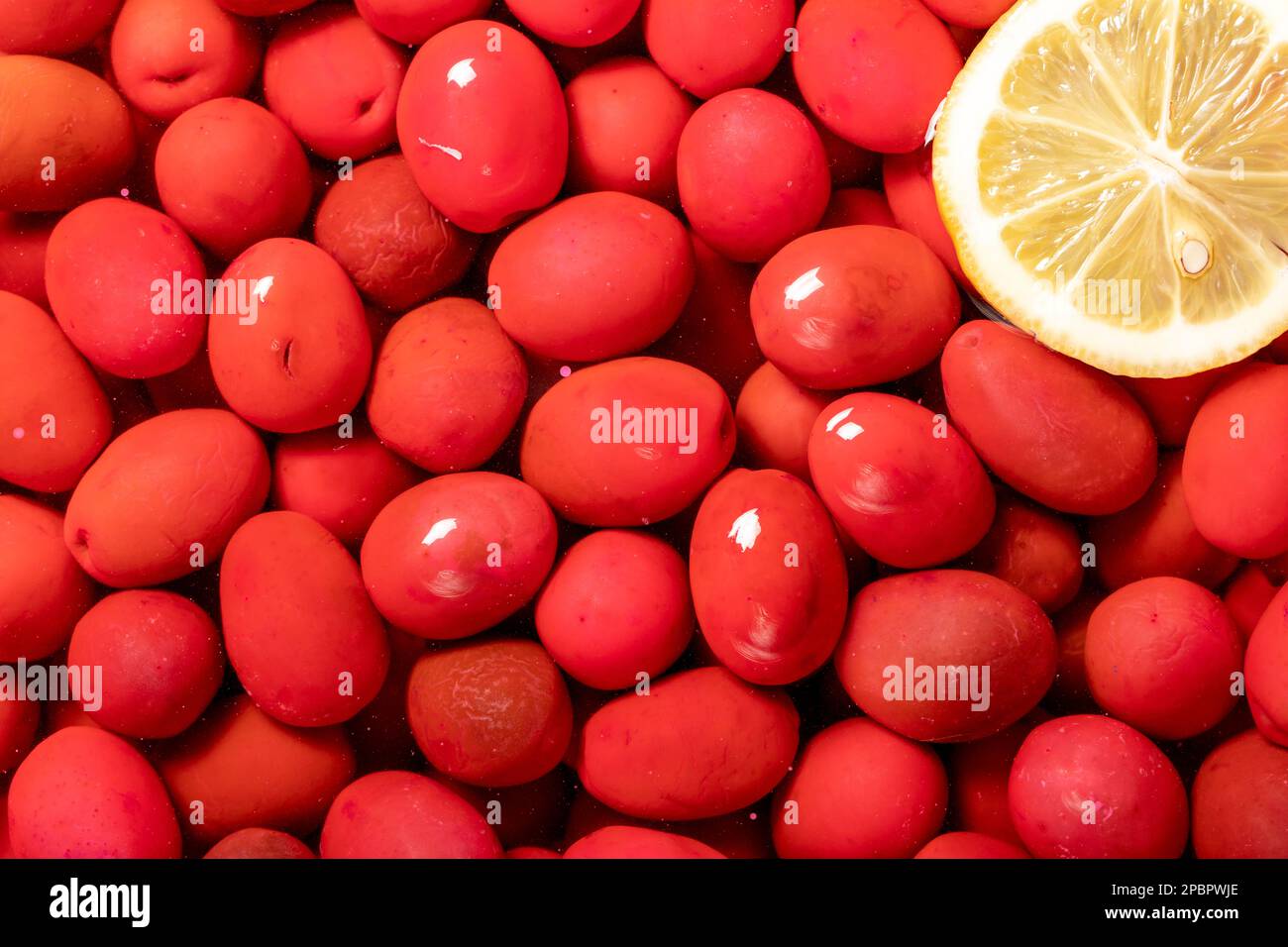 Beet flavored olives. Close-up pile of red kalamata olives Stock Photo ...