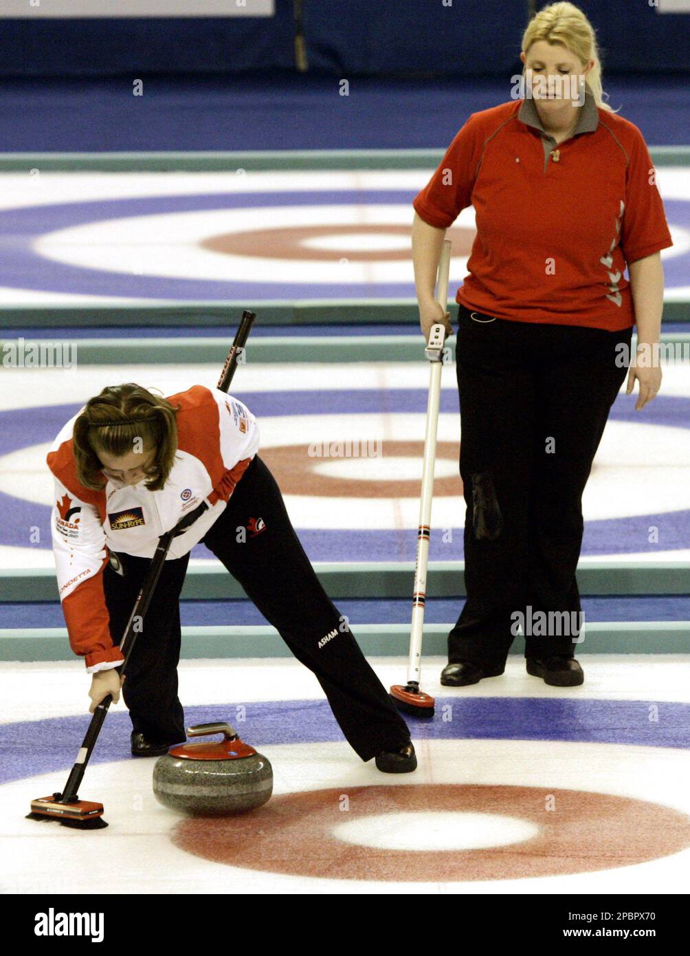 Denmark's skip Angelina Jensen, right, looks on as Canada's skip Kelly ...
