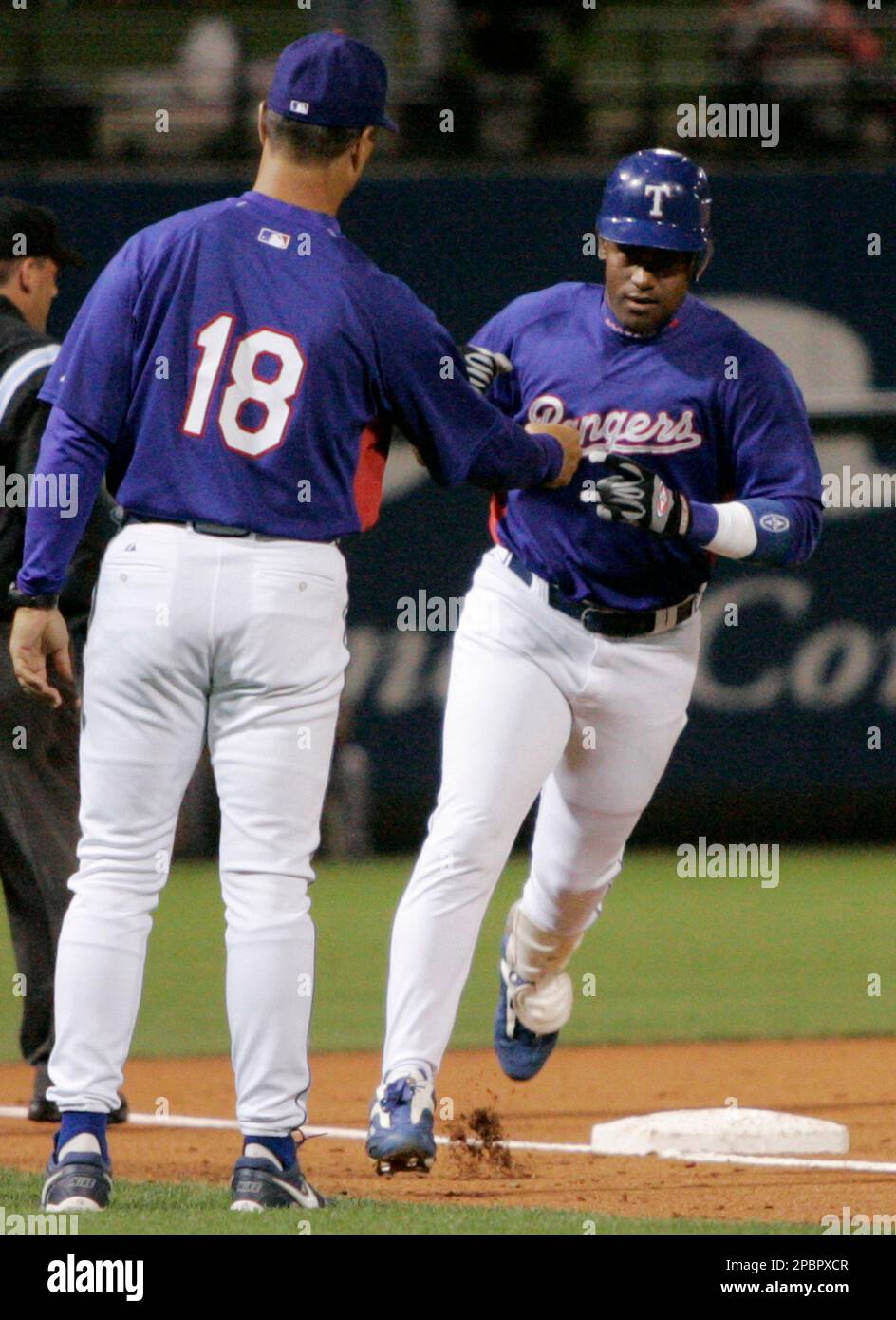 Texas Rangers' Sammy Sosa, right, rounds third as base coach Don ...