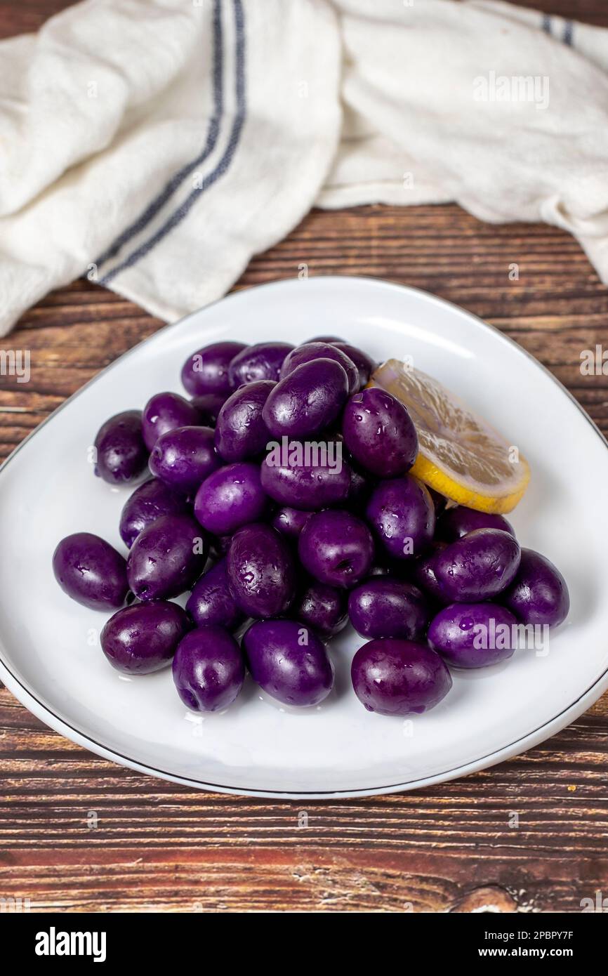 Kalamata olive with blueberries flavor. Purple olives on wood ...