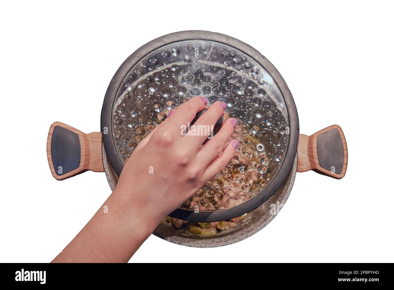 A woman hand opens the lid of a pot standing on an electric kitchen ...