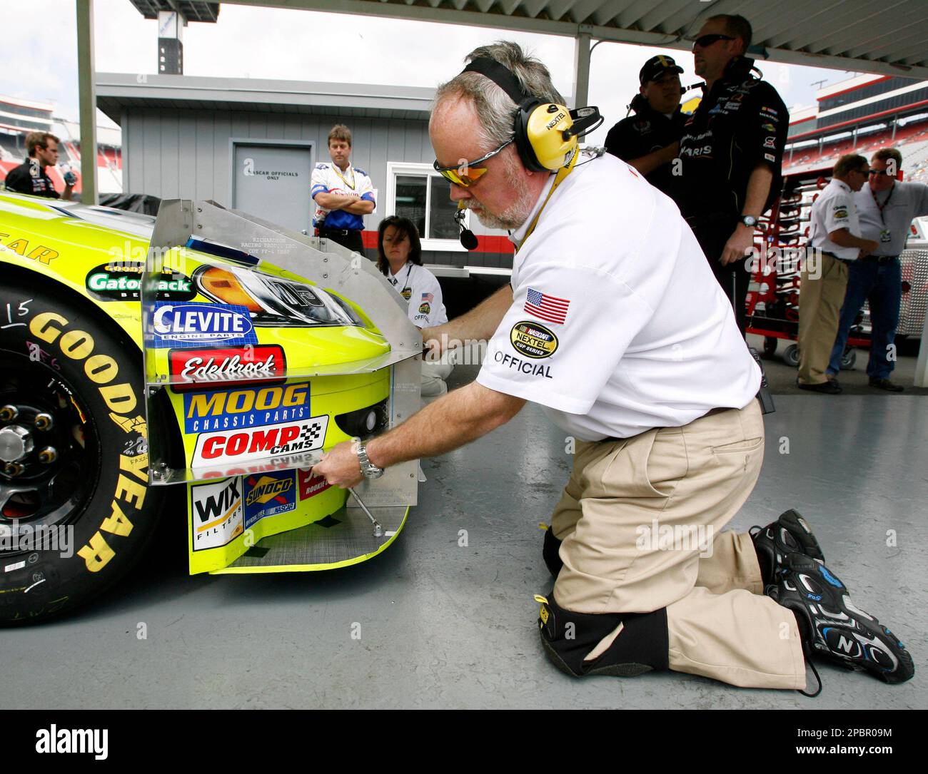 NASCAR official Jerry Hines inspects the car of driver Paul Menard ...