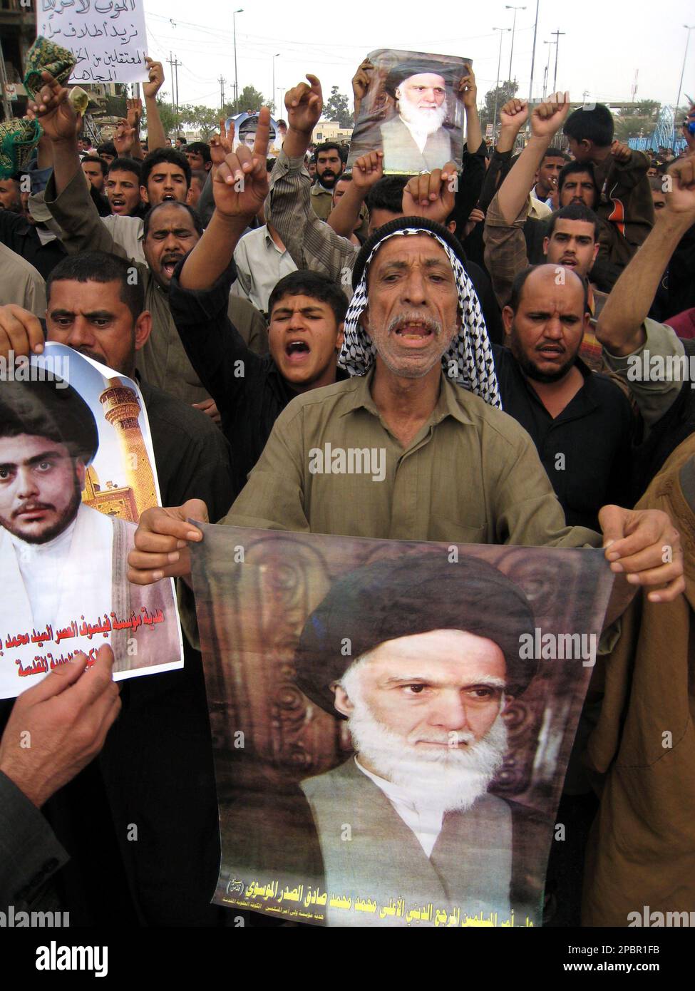 People carry posters showing anti-US radical cleric Muqtada al-Sadr, on ...