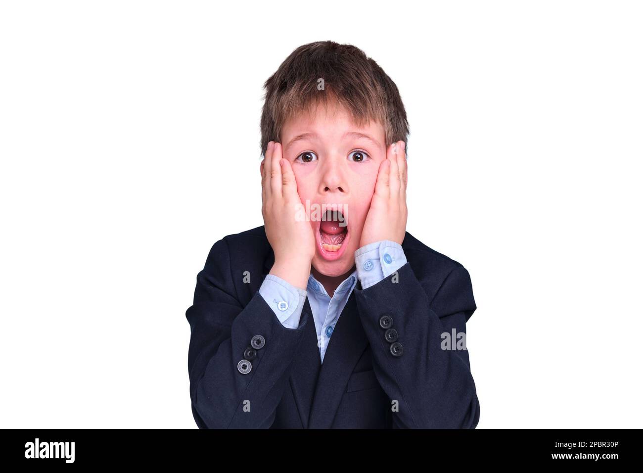 A scared boy in a school suit on distance learning, isolated on a white ...