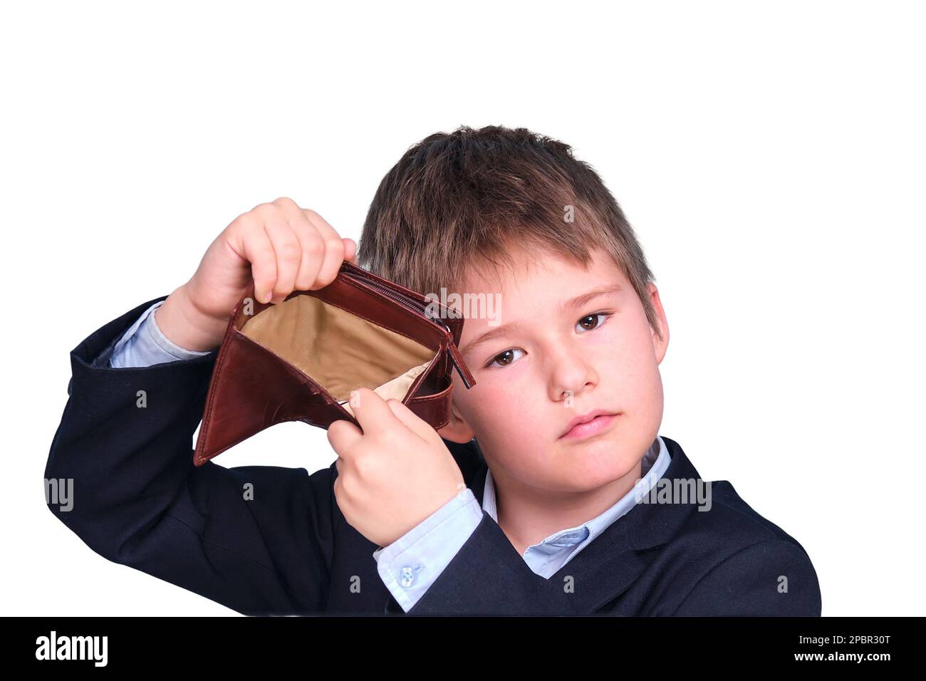A boy in a school suit with an empty wallet, isolated on a white ...