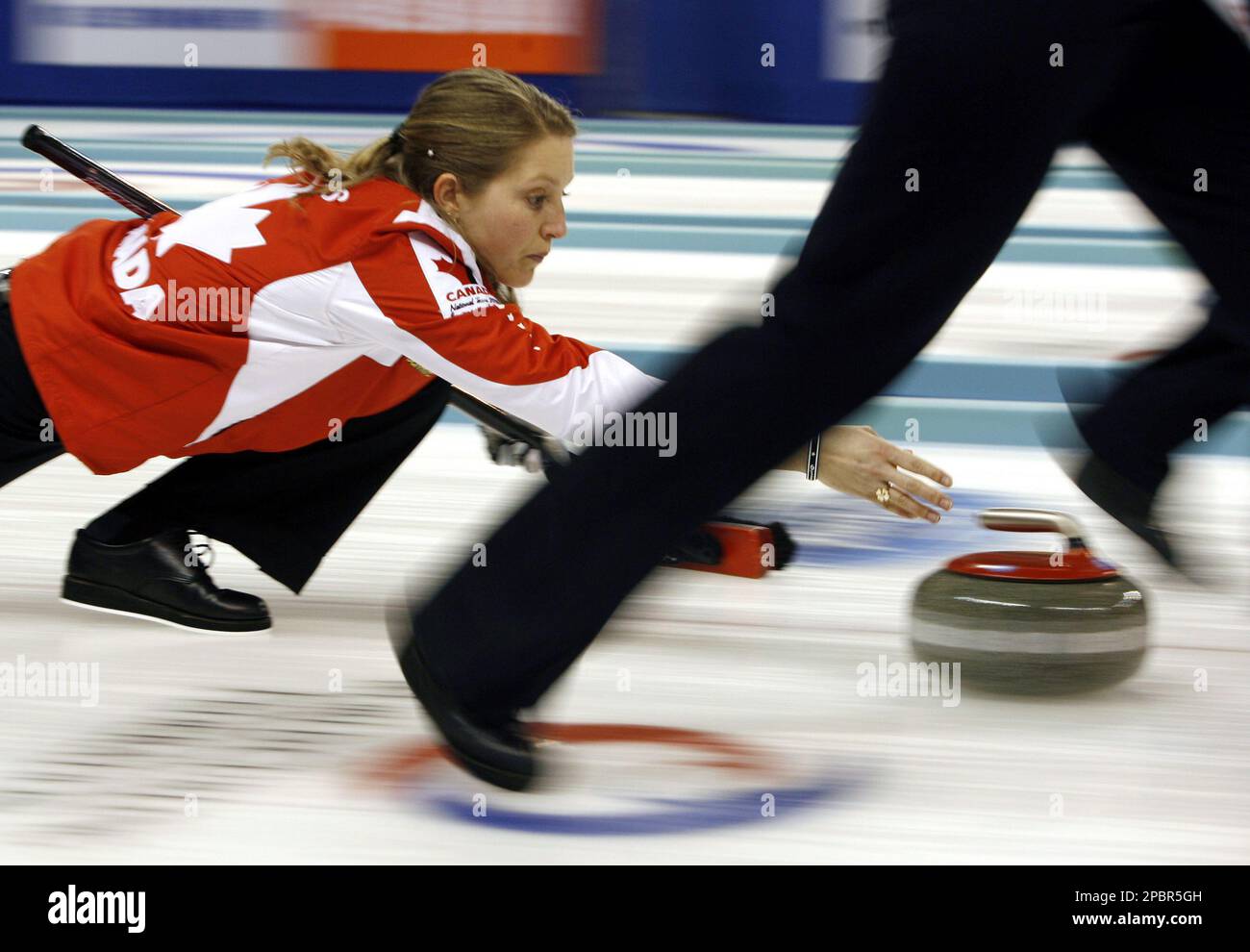 Canada's Renee Simons releases a stone to teammates during the Women's ...
