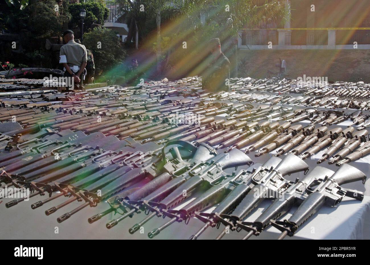 Filipino soldiers look at 1,600 assorted rifles as they are prepared ...