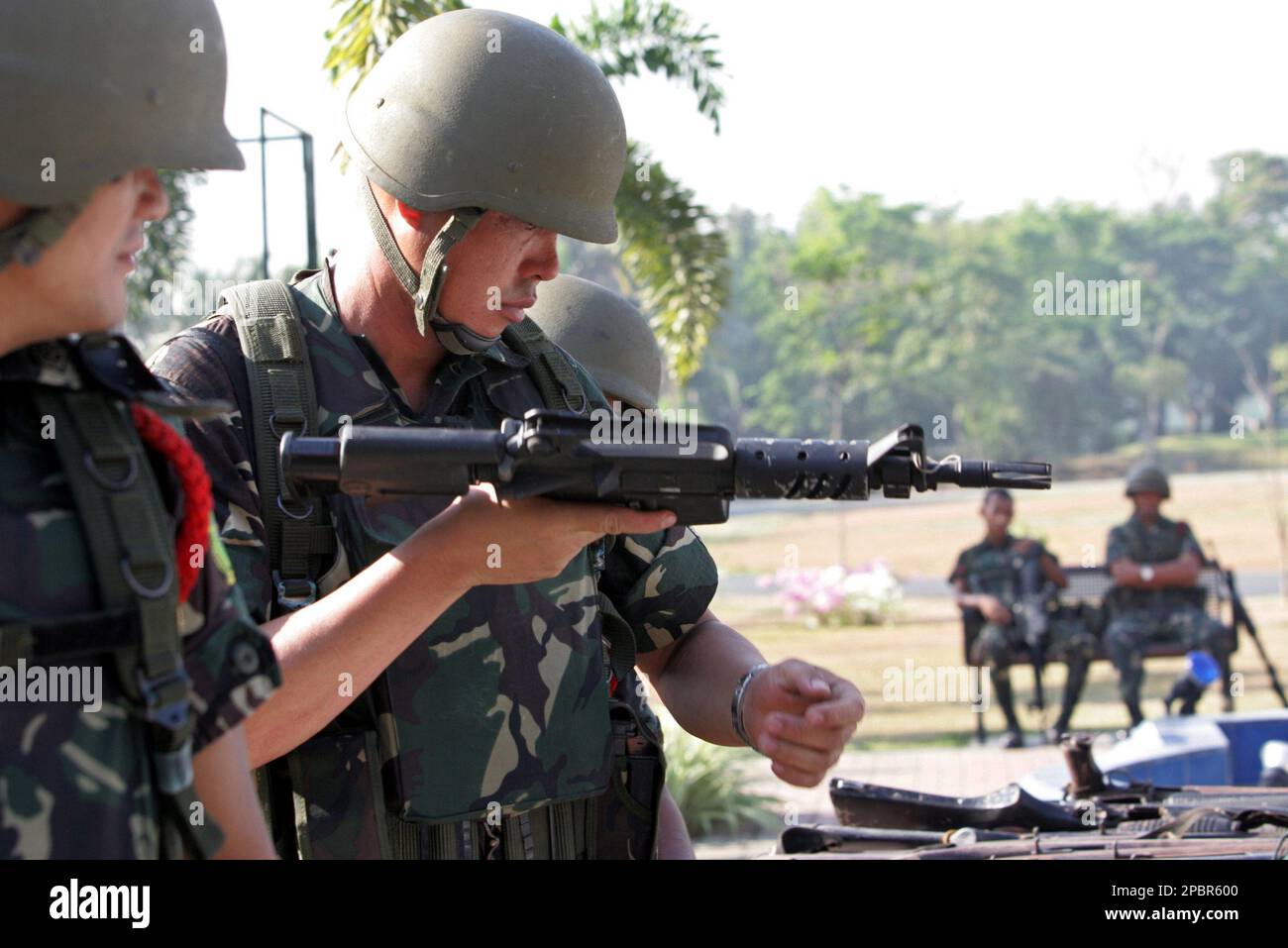 A Filipino soldier holds an assault rifle, one of 1,600 assorted rifles ...