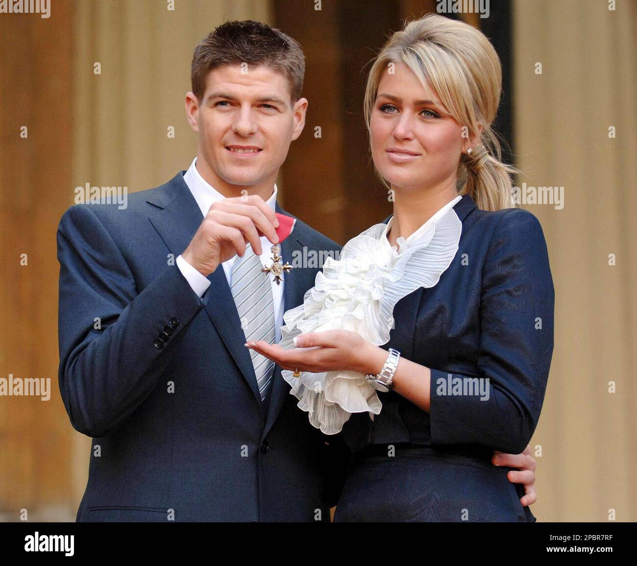 Liverpool captain Steven Gerrard stands with his partner Alex Curran ...