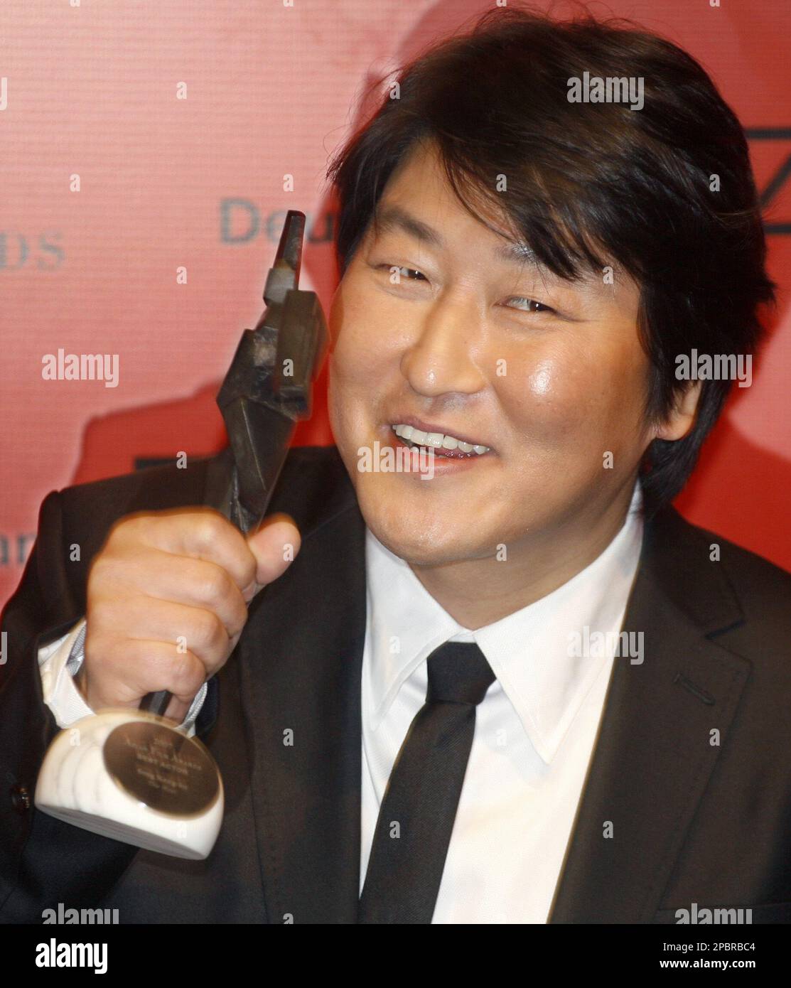 South Korean actor Song Kang Ho raises his best actor award at the ...