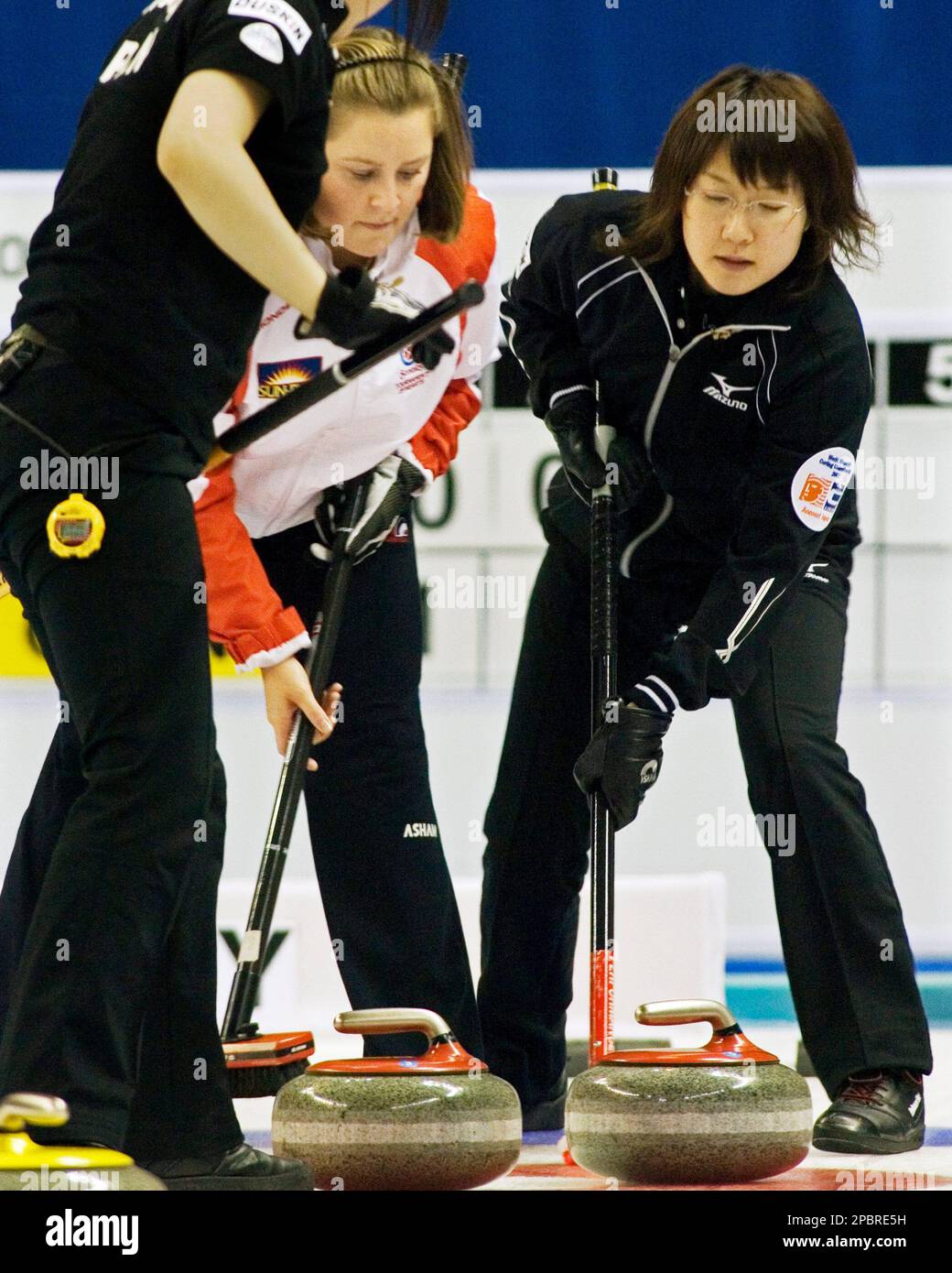 Team Canada skip Kelly Scott, left, and Japan skip Moe Meguro work on a ...